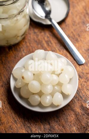 Pickled mini baby onions on plate Stock Photo - Alamy
