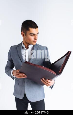 Handsome man with folder man reading a menu, a stylish business guy in ...