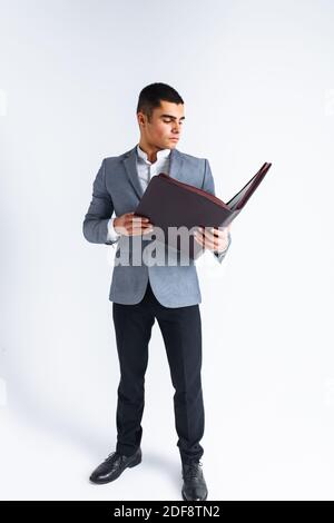 Handsome man with folder man reading a menu, a stylish business guy in ...