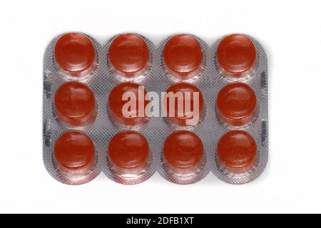 Orange flavour sore throat lozenges in silver packaging Stock Photo - Alamy