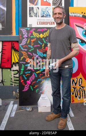 Street artist Gregos is seen as a street art performance takes place to ...