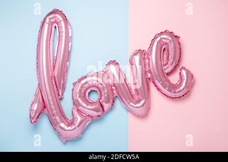 Pink balloons in the form of word Love on blue background. Valentines ...