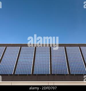Solar panels on blue sky background Stock Photo - Alamy