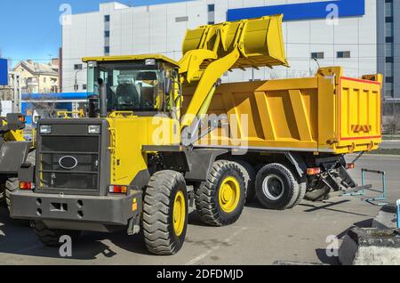 front loader loading the truck (all logos, inscriptions and markings ...