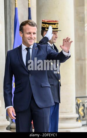 French President Emmanuel Macron, gestures as he poses for a photograph ...