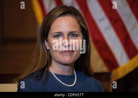 Supreme Court nominee Judge Amy Coney Barrett (R) speaks with ...