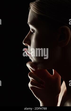 sad female face profile silhouette on black background Stock Photo - Alamy