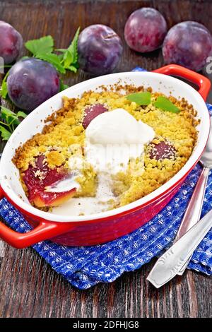 Delicious plum cake with crumble and ice cream on a white table Stock ...