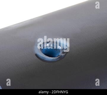 Blue thread locking solution in a rifle receiver hole used to hold a ...