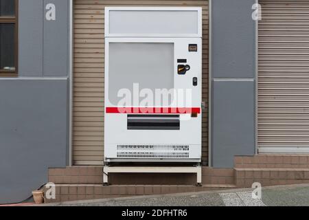 Empty white shelves of standard office vending machine Stock Photo - Alamy