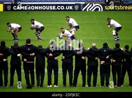 Georgia players look on as Fiji players perform the haka prior to the ...