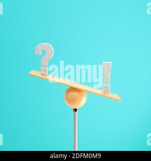 wooden scale balancing a question mark and an exclamation mark on white ...