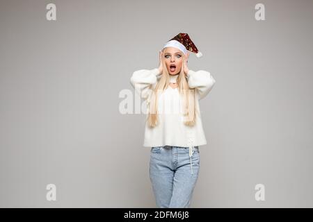 Woman cupping hands at mouth calling out inside an arched building ...