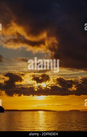 The setting sun reflecting onto the sea Stock Photo - Alamy
