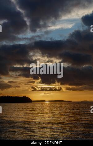 The setting sun reflecting onto the sea Stock Photo - Alamy