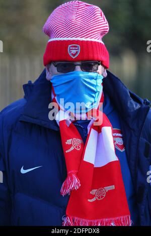 An Arsenal fan wearing a face mask takes his seat for the match, before ...