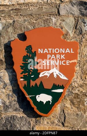 National Park Service logo shield on a rock wall, Grand Portage ...