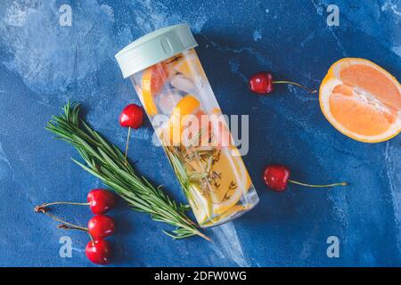 Bottle of herbal infused water with citruses on color table Stock Photo ...