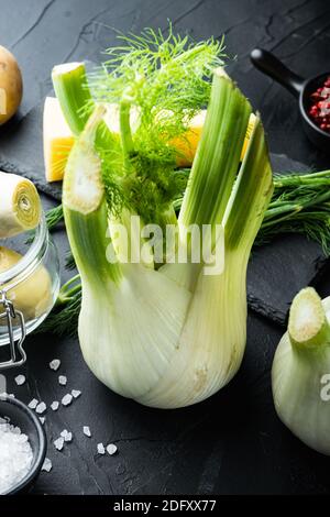 Fennel bulbs, on black textured background, top view with space for ...