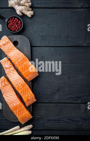Fishcakes ingredient with salmon herbs and spices, on black wooden ...