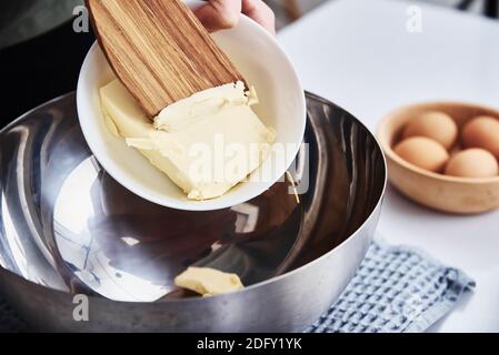 Hands put a butter in bowl. Cooking recipe Stock Photo - Alamy