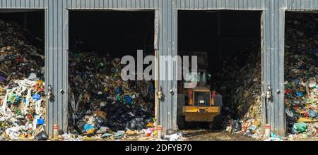 Huge industrial warehouse of household waste. Dump of big city. White ...