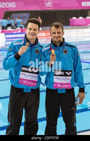 Divers Sascha Klein (R) and Patrick Hausding of Germany take a shower ...