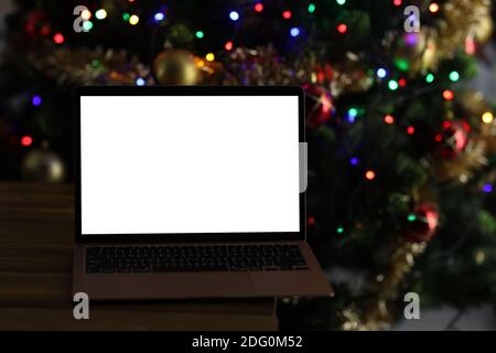 Laptop and Christmas decor on standing desk near white brick wall Stock ...