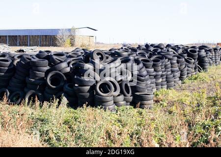 Industrial dump for the processing of used tires and rubber tires. Pile ...