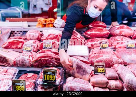 Woman choosing from meat counter Stock Photo - Alamy