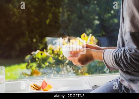 cropped view of woman holding cup of coffee at morning Stock Photo - Alamy