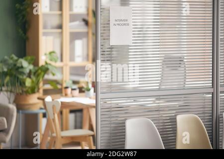 Background image of office room with sign Interview in progress on ...