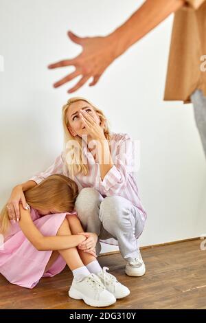 Child abuse. Mother yelling at her daughter. Shadow of woman on wall ...