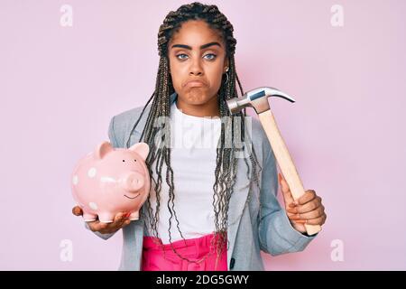 young worried has to break a piggy money bank Stock Photo - Alamy