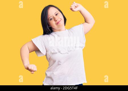 Woman with down syndrome wearing sleeping mask hugging pillow worried ...