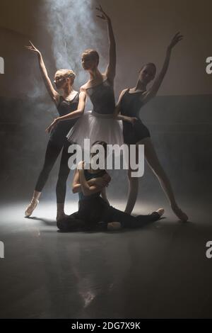 Quartet of young ballet dancer, in flowing white costumes with blue ...