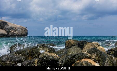 Huge jumping rock in crystal blue clear sea water, rocky island beach ...