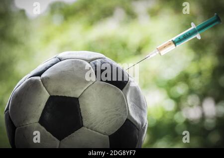 Soccer ball gets an injection with a syringe, doping in sports Stock ...