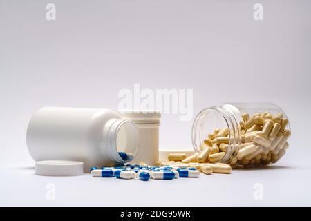 Medications capsules in plastic bottles on light grey background Stock ...