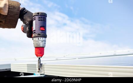 Installation process, with drill. Engineer with photovoltaic solar ...