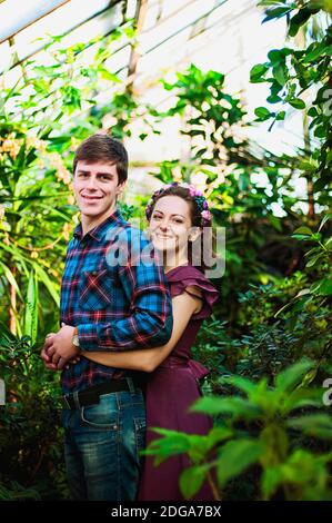 Young couple in greenhouse on spring day Stock Photo - Alamy