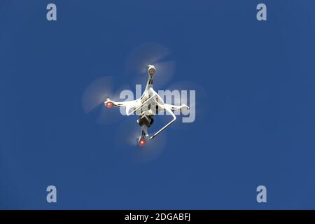 A Group Of Drones Fly Together Through The Air Against A Blue Sky Stock ...