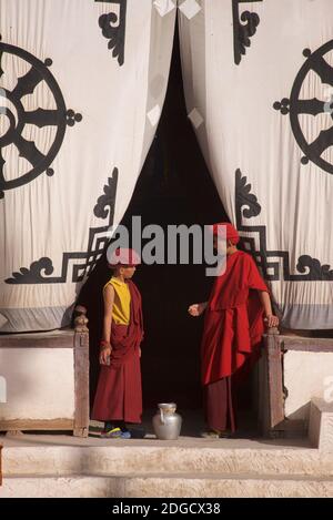 Early morning at Hemis monastery. A young monk at the entrance to the ...