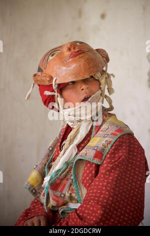 A Tibetan Buddhist in traditional outfit performing Dance with a Damaru ...
