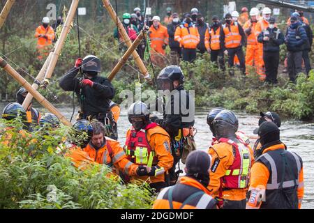 Police officers from the Protester Removal Team work to free a Just ...