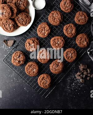 Overhead view of salted dark chocolate cookies on black counter Stock ...