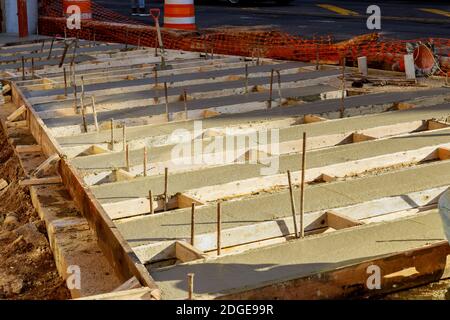 Concrete curb installation. Sidewalk pavement renewal. Road ...