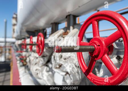 New shut-off valves with red flywheel installed on new process pipeline ...
