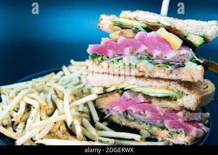Tall club sandwich and french fries Stock Photo - Alamy