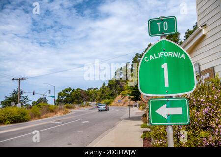 California highway 1. Green sign on the street against blue sky ...
